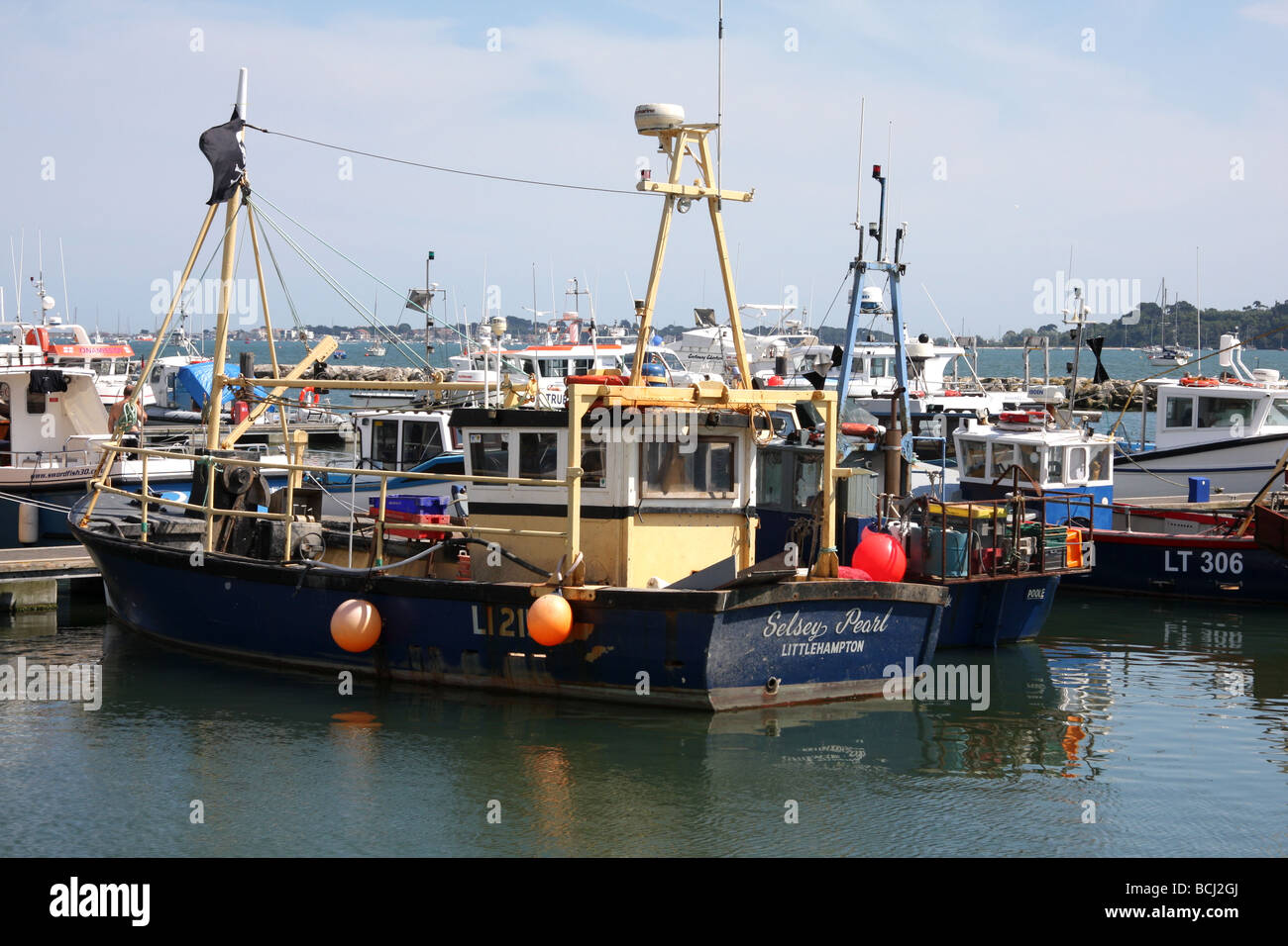 Fishing boats moored in Poole Harbour, Dorset, UK Stock Photo - Alamy