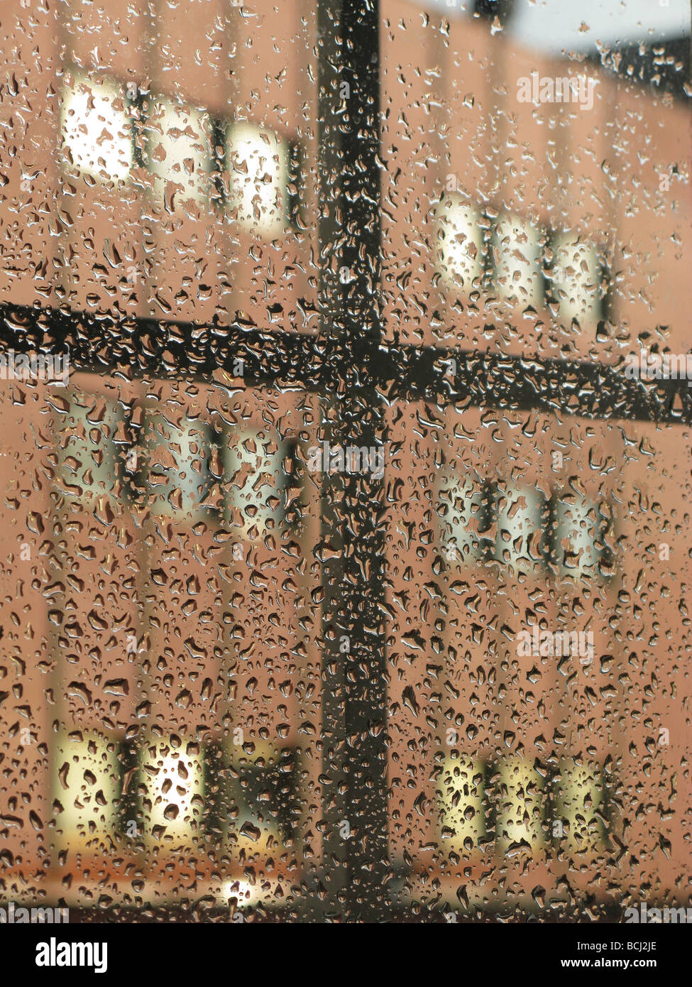 modern office block seen through rain drops covered window Stock Photo ...
