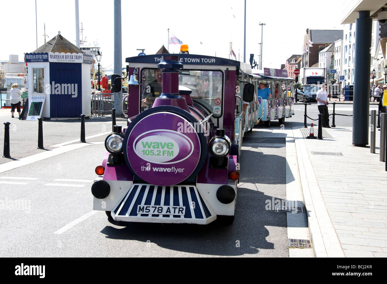 Road train running along edge of harbour, Poole, Dorset, UK Stock Photo ...