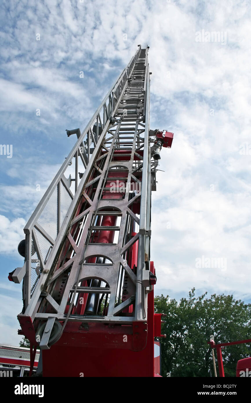 The fire ladder lifted highly in the sky Stock Photo - Alamy
