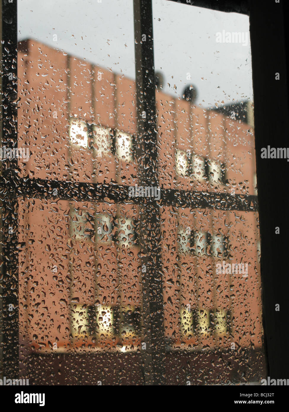 modern office block seen through rain drops covered window Stock Photo ...