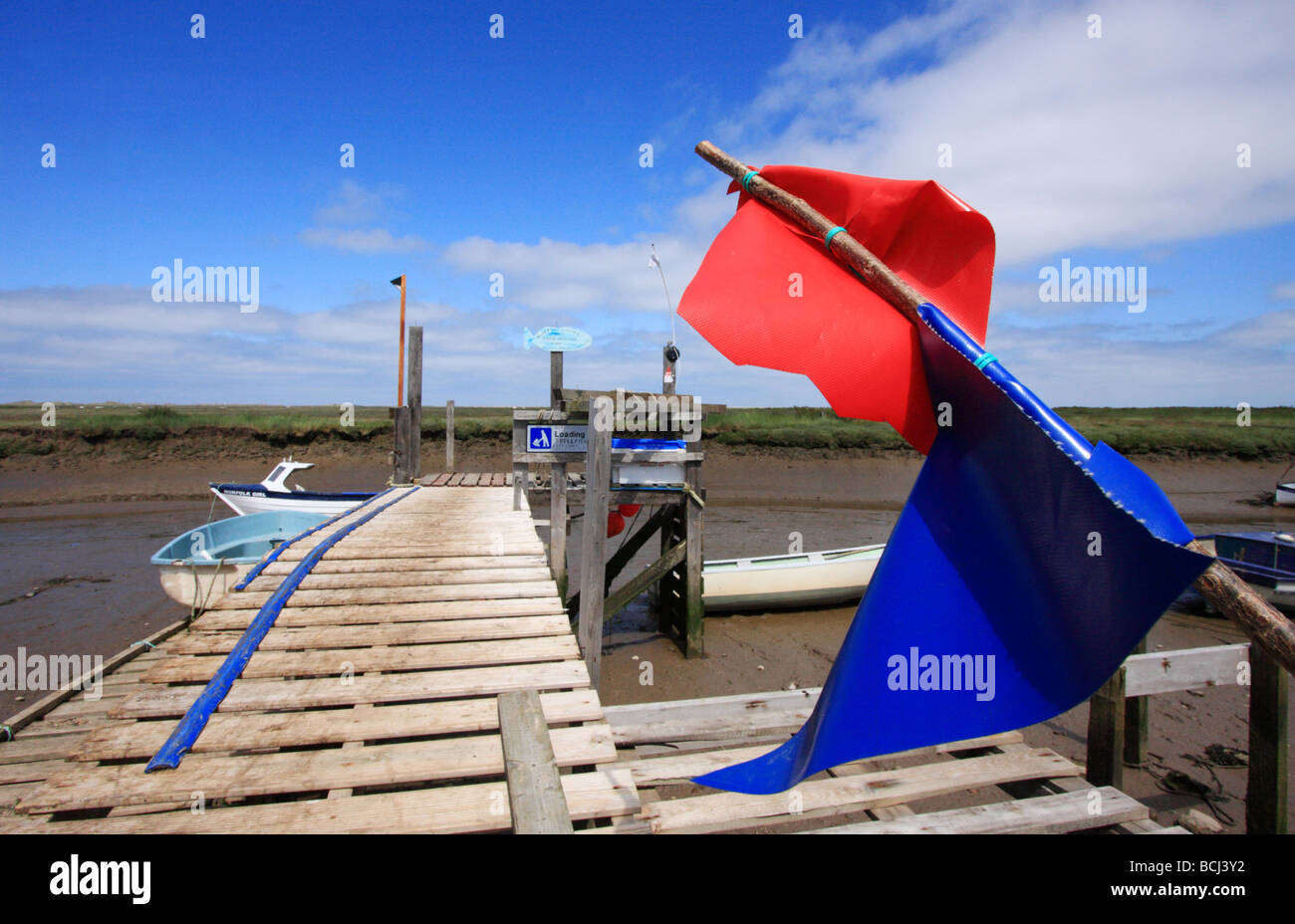 Bright red and blue marker flags on a jetty Stock Photo - Alamy