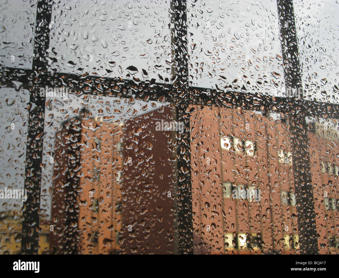 modern office block seen through rain drops covered window Stock Photo ...