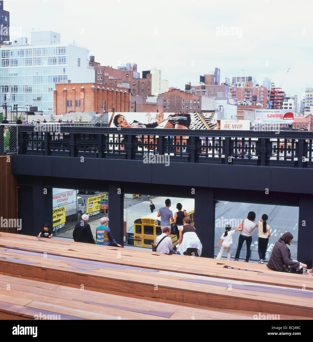 High Line Park wooden seating and structure with people viewing city ...