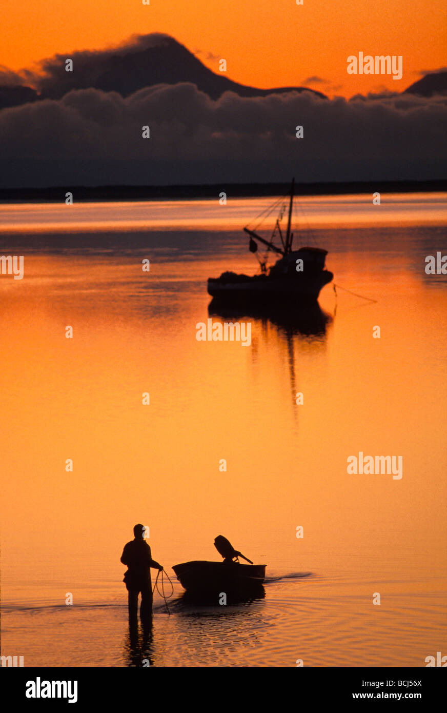 Man with skiff & fishing boat Chignik Lagoon SW AK sunset Stock Photo ...