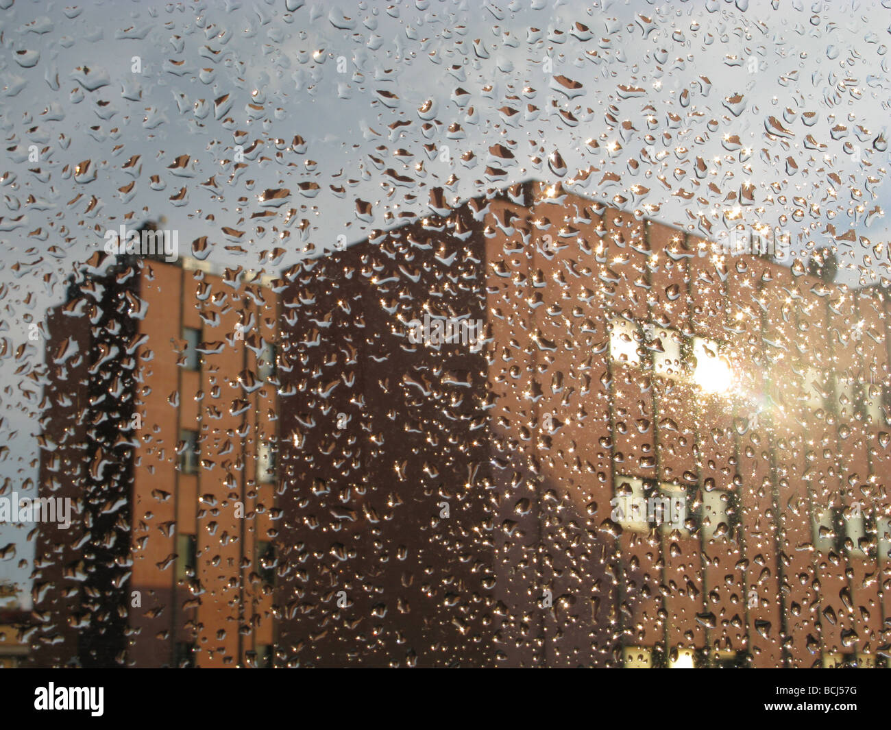 modern office block seen through rain drops covered window Stock Photo ...
