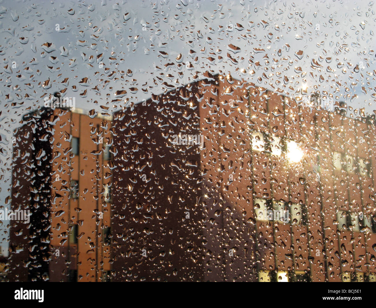 modern office block seen through rain drops covered window Stock Photo ...