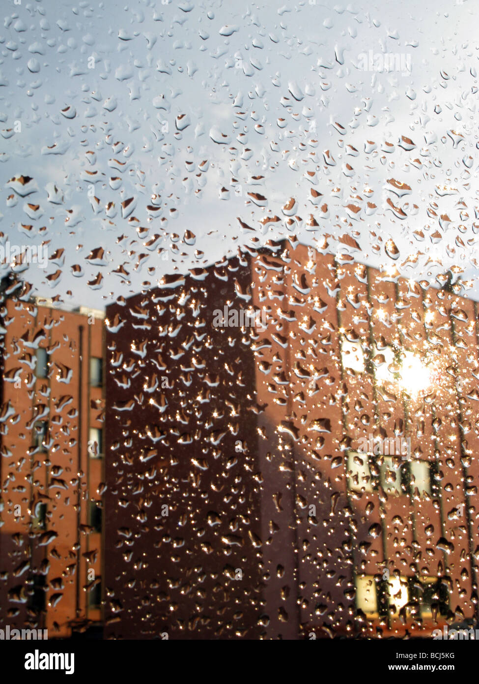 modern office block seen through rain drops covered window Stock Photo ...