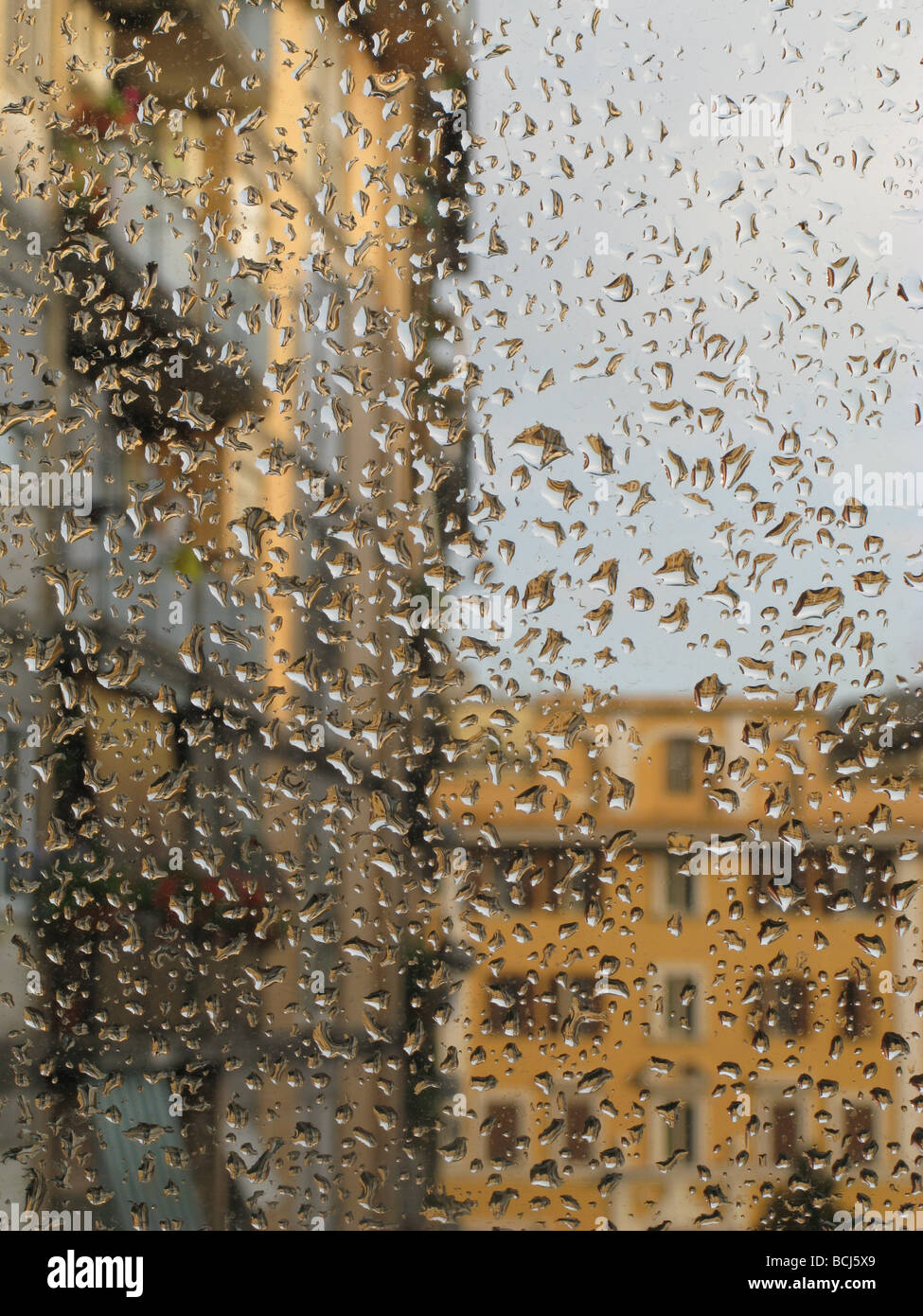 modern buildings seen through rain drops covered window Stock Photo - Alamy