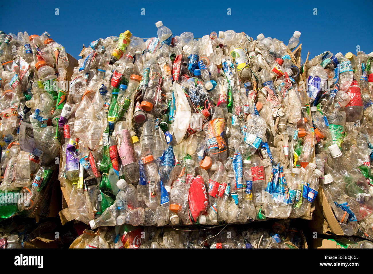 Bale of crushed plastic drink containers at recycling yard plant in ...