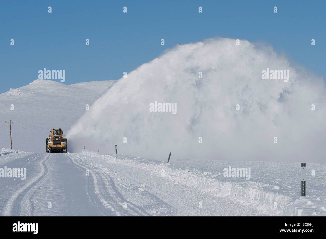 Snow plow removes snow from road near Nome, Alaska during Winter Stock ...