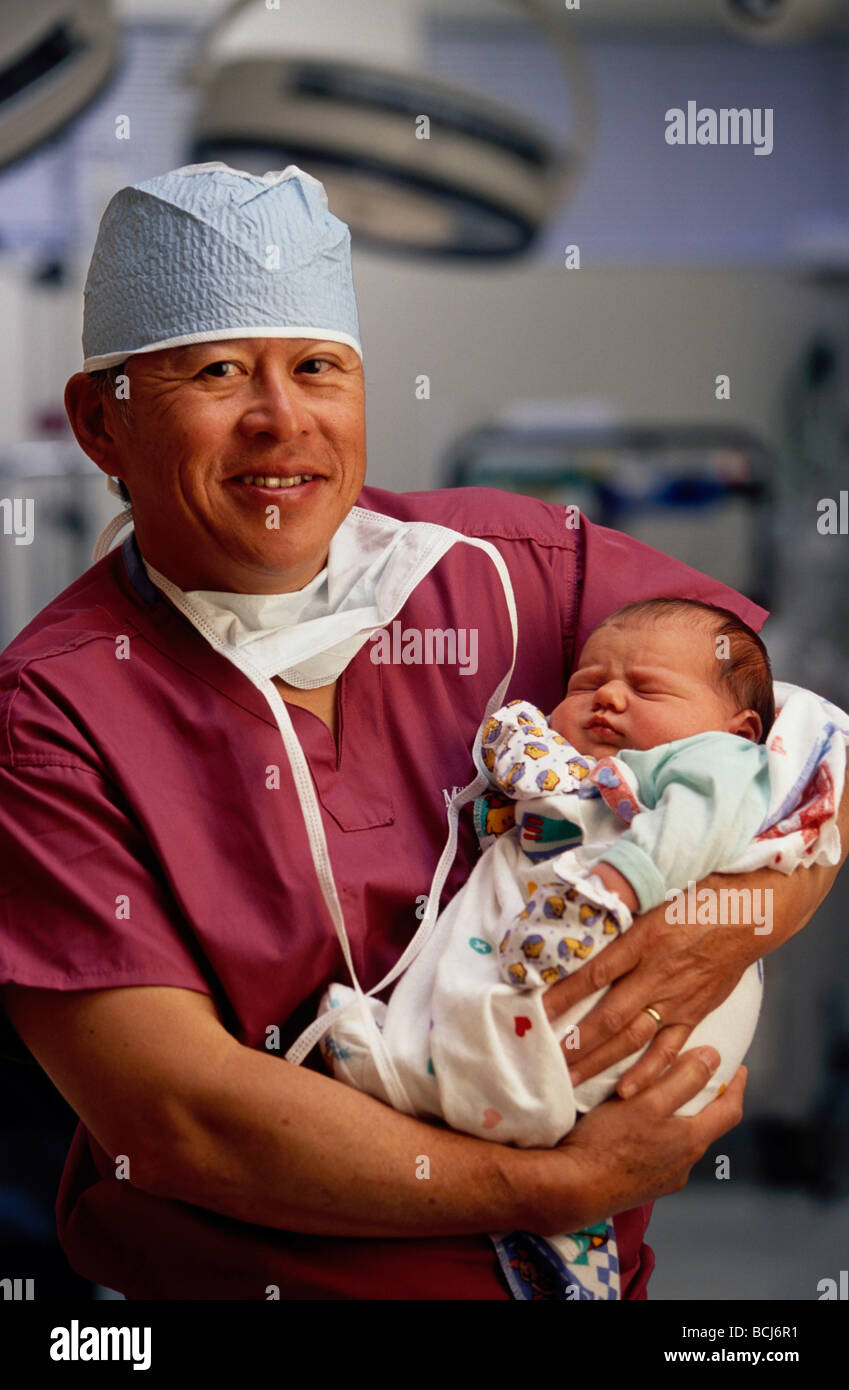 Doctor in Surgical Gown w/ Newborn Baby Alaska Stock Photo - Alamy