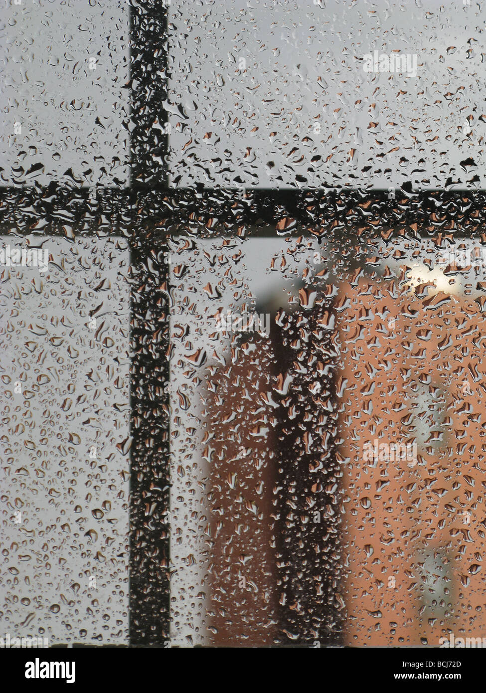 modern buildings seen through rain drops covered window Stock Photo - Alamy