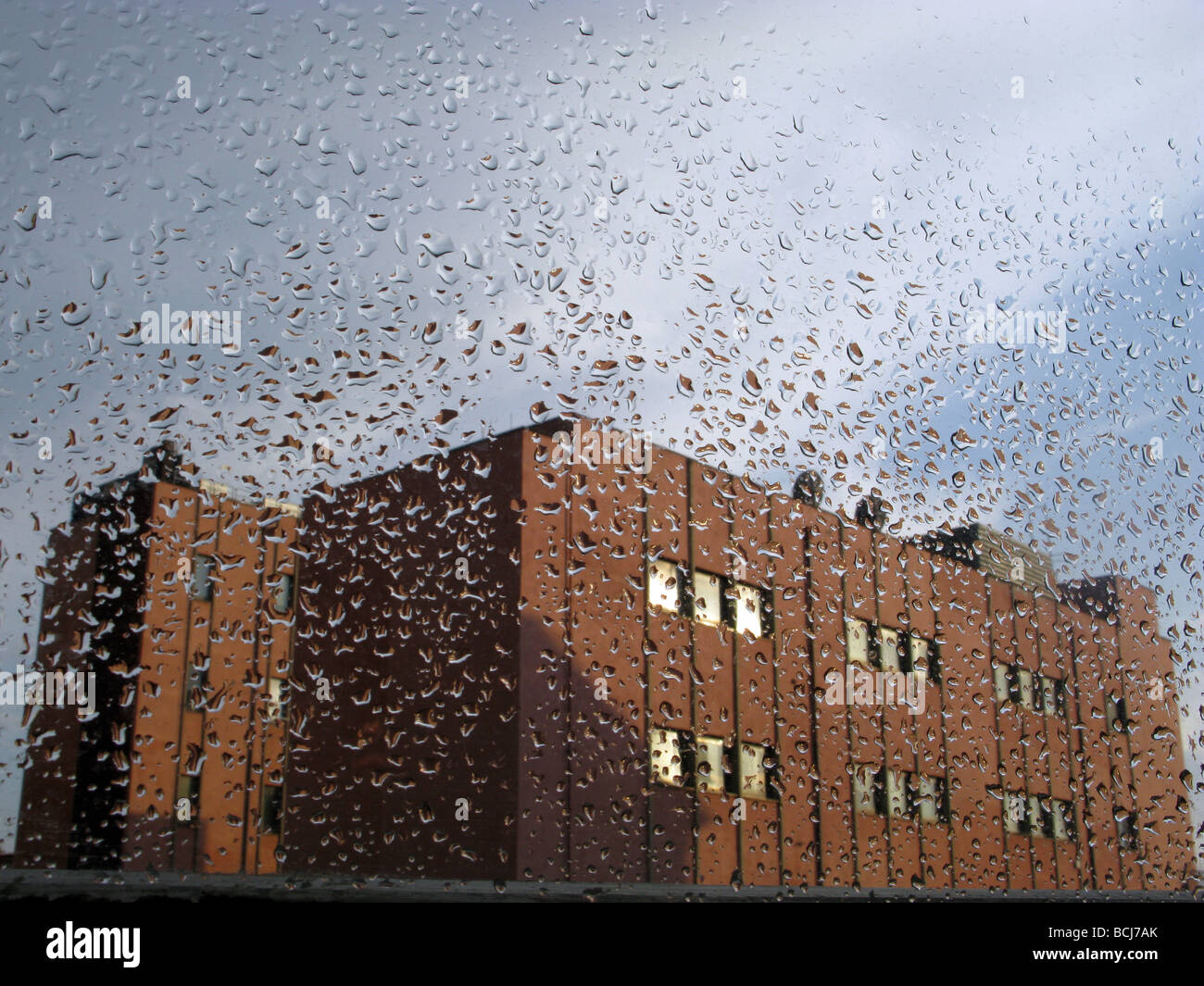 modern office block seen through rain drops covered window Stock Photo ...