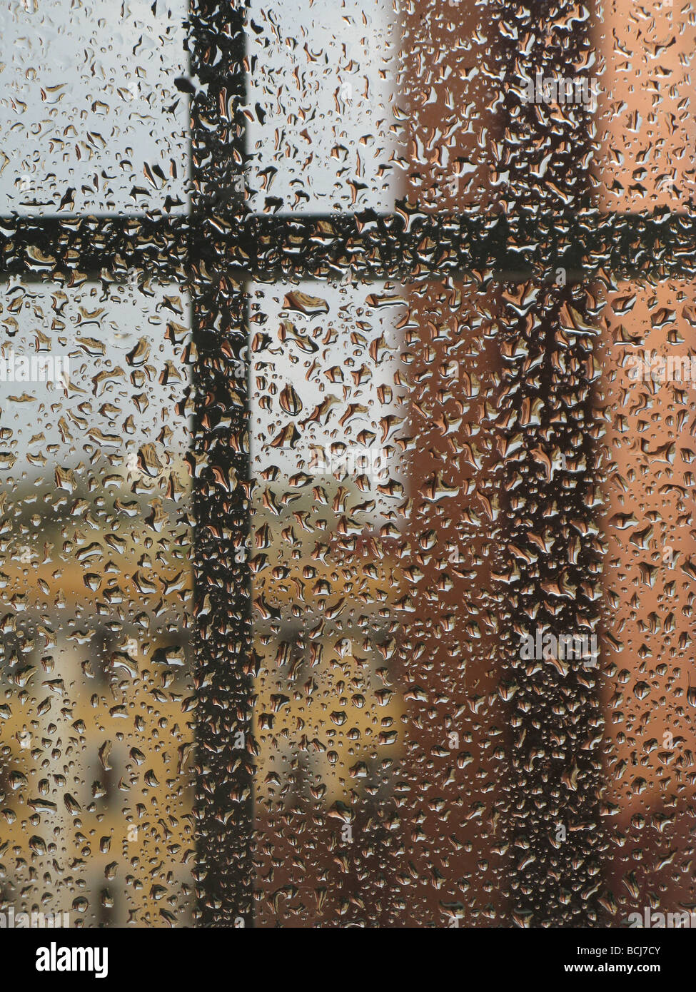 modern buildings seen through rain drops covered window Stock Photo - Alamy