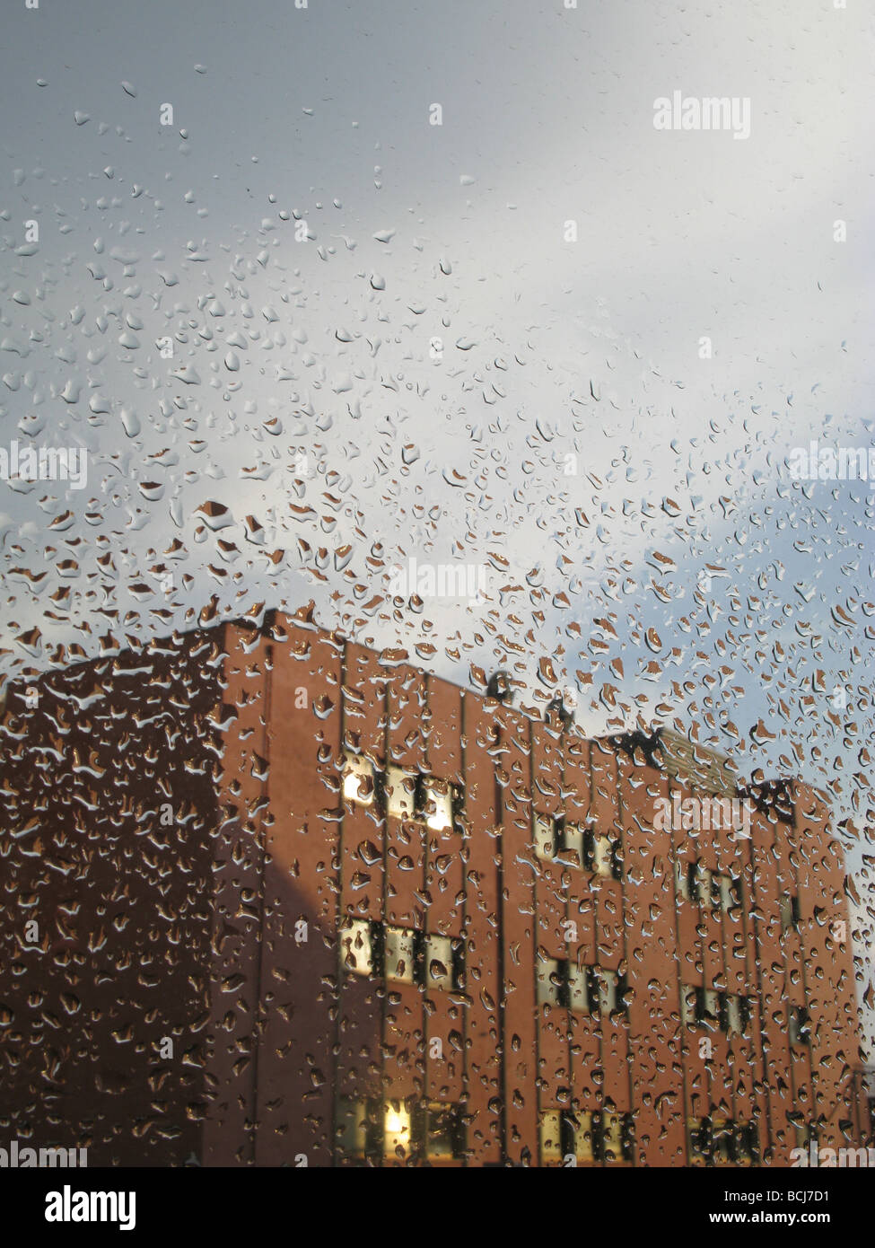modern office block seen through rain drops covered window Stock Photo ...