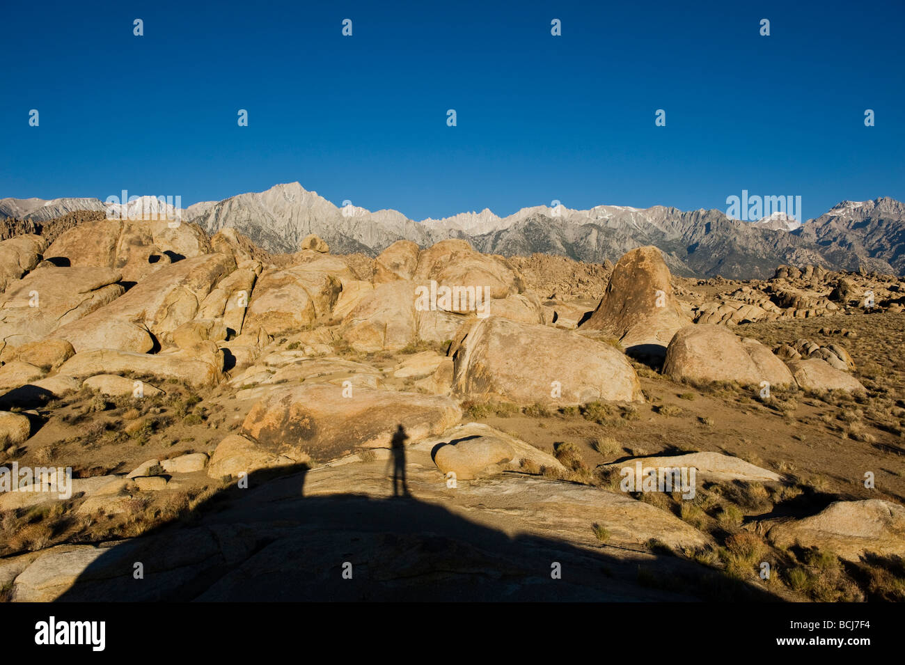 Shadow of person standing on rock with Sierra Nevada Mountains in ...