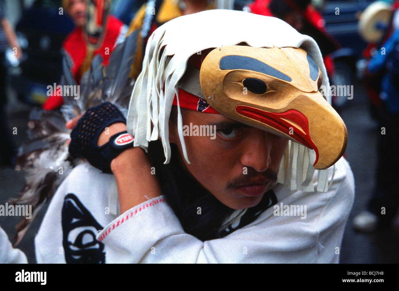 Native Alaskan with traditional wooden carved mask in Juneau Alaska USA ...