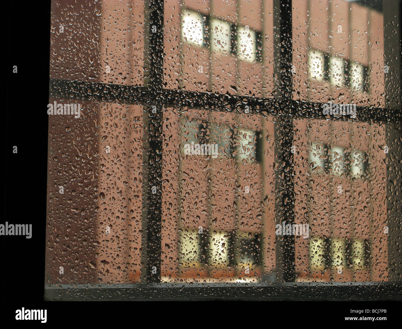modern buildings seen through rain drops covered window Stock Photo - Alamy