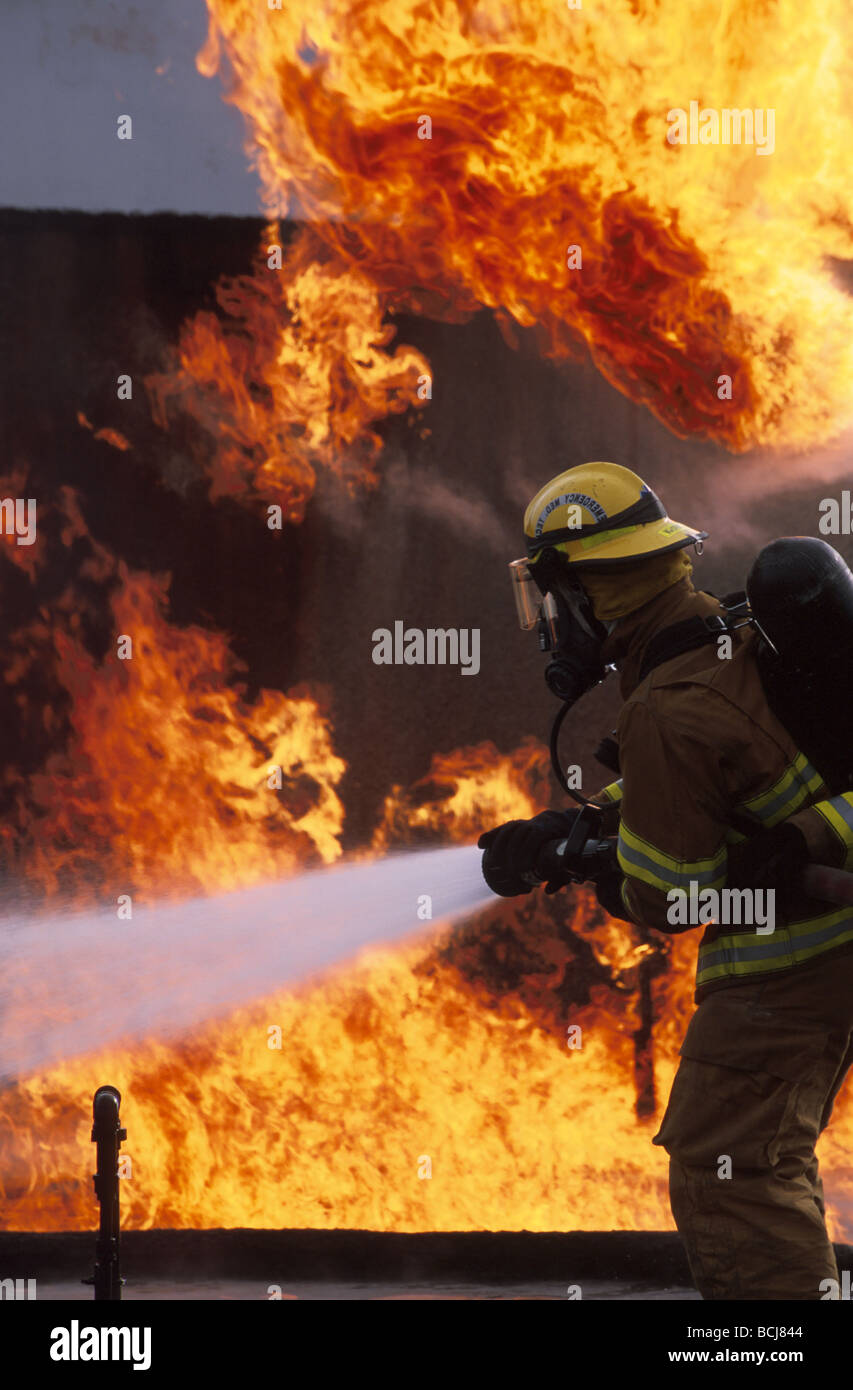Fireman with hose hi-res stock photography and images - Alamy