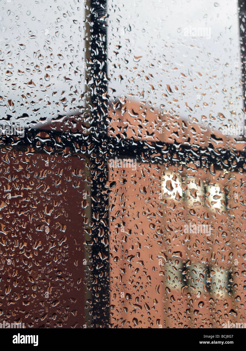 modern office block seen through rain drops covered window Stock Photo ...