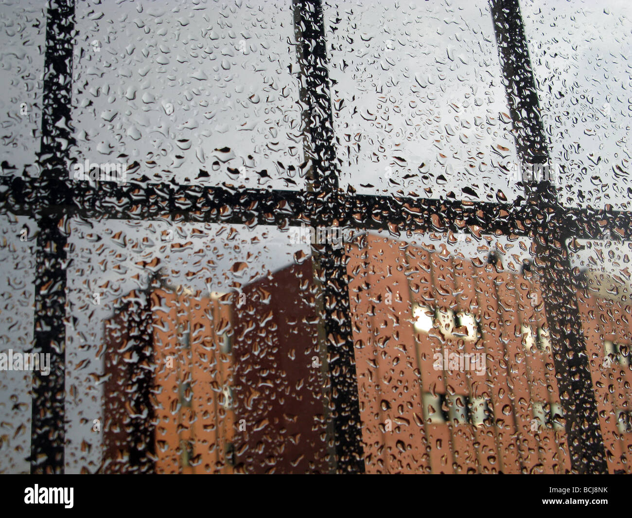 modern office block seen through rain drops covered window Stock Photo ...