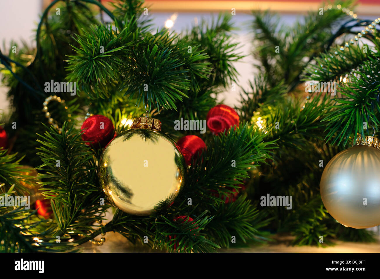 COMPOSITE Santa listens to young child reflected in a tree ornament ...