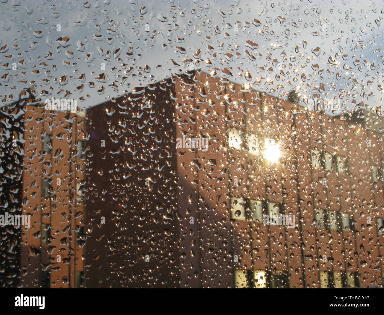 modern office block seen through rain drops covered window Stock Photo ...