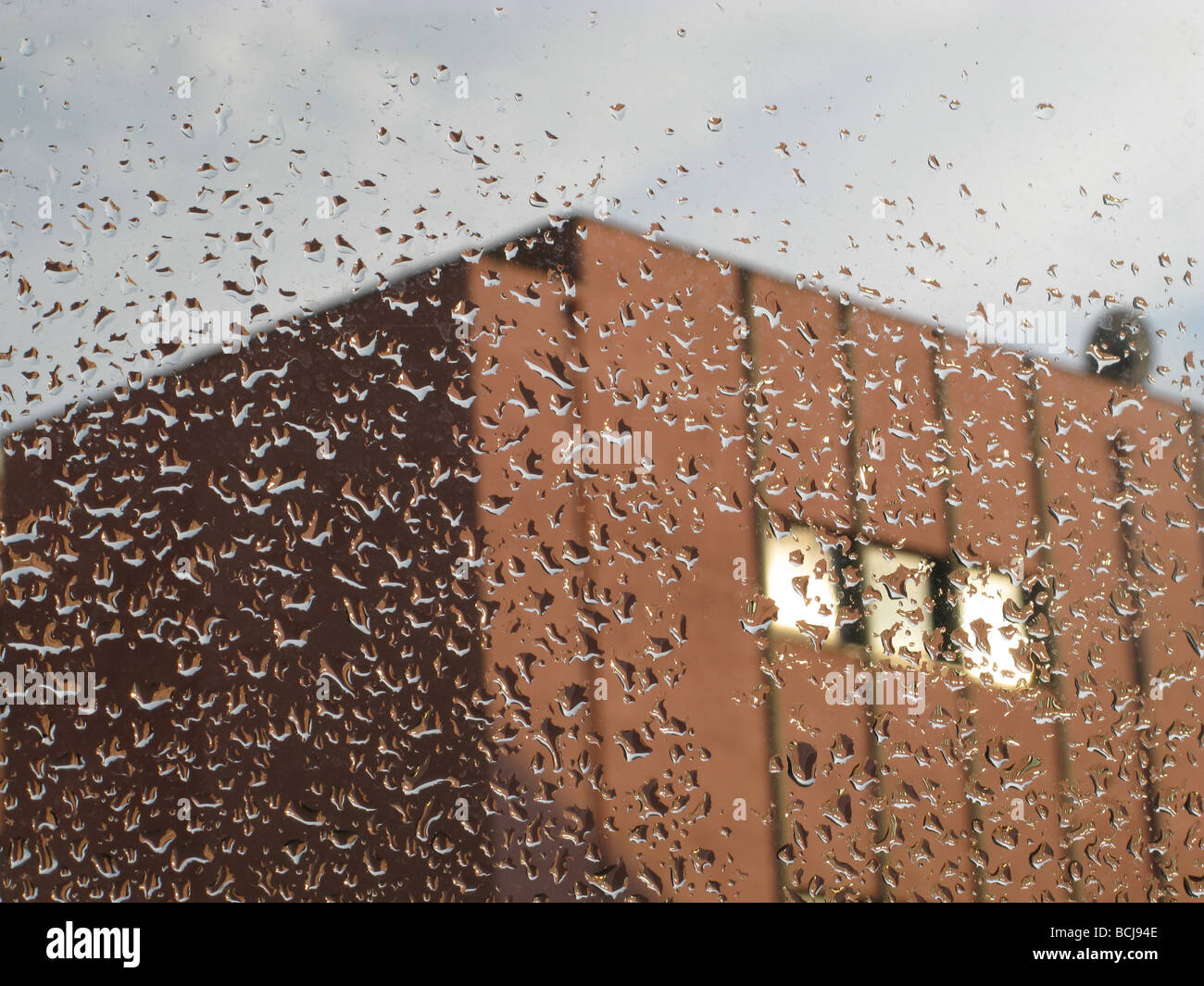 modern office block seen through rain drops covered window Stock Photo ...