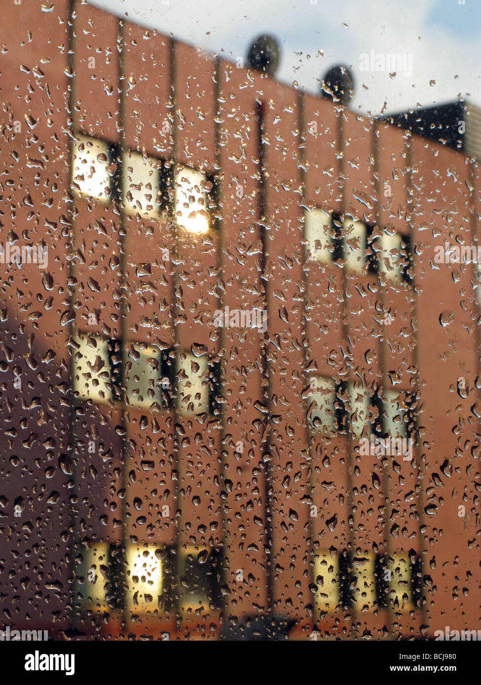 modern office block seen through rain drops covered window Stock Photo ...