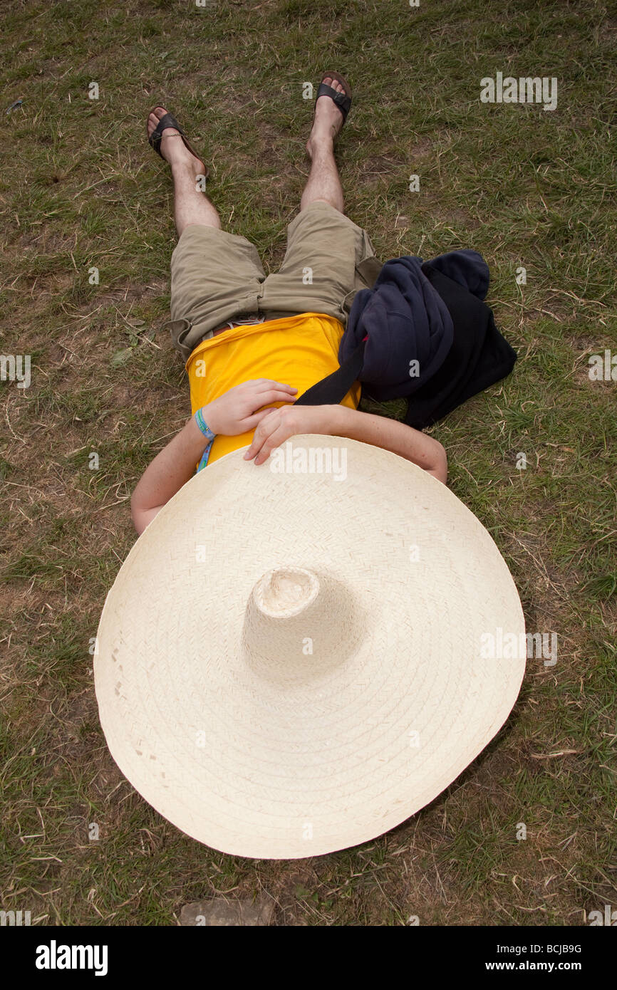 Man sleeping under a giant mexican hat at Glastonbury festival 2009 ...