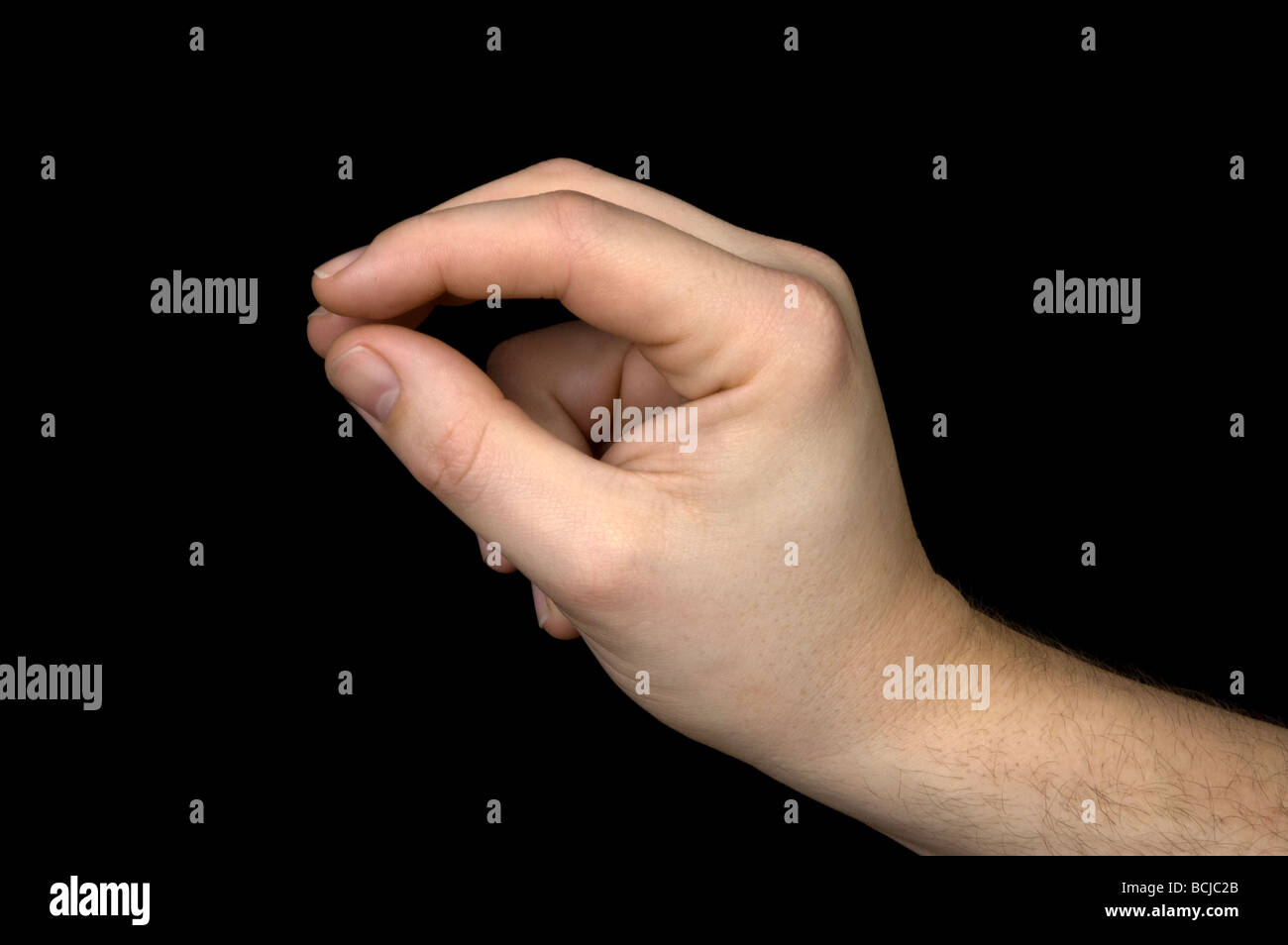 male hands enclosing and encompassing and cupping against black Stock ...