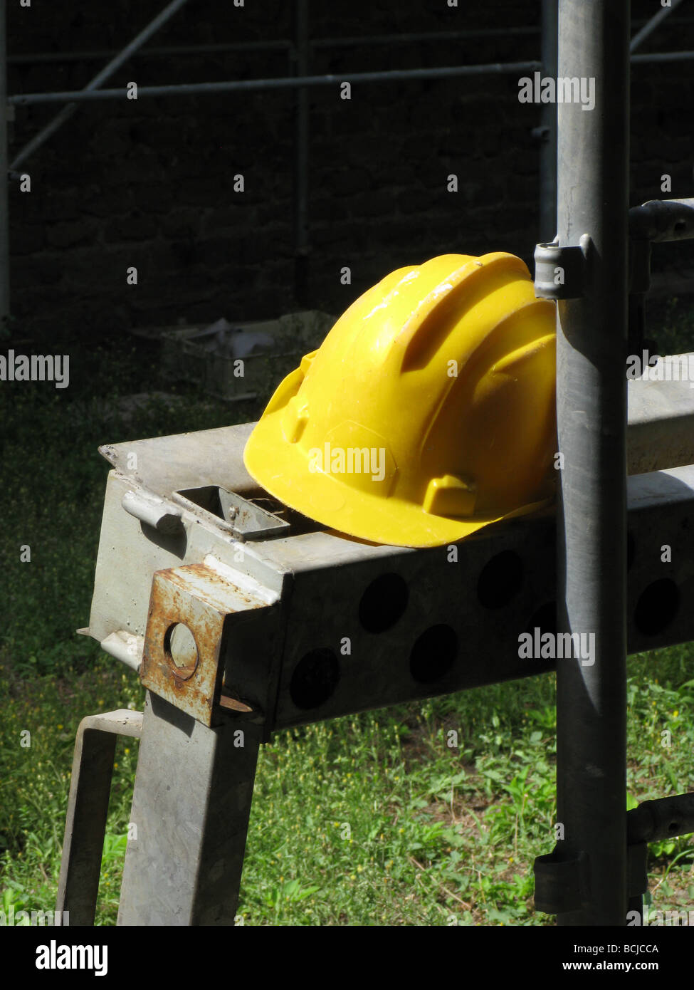 one builder's protective head hard hat on scaffolding on building site ...