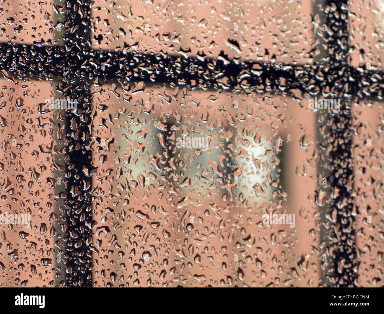 modern office block seen through rain drops covered window Stock Photo ...