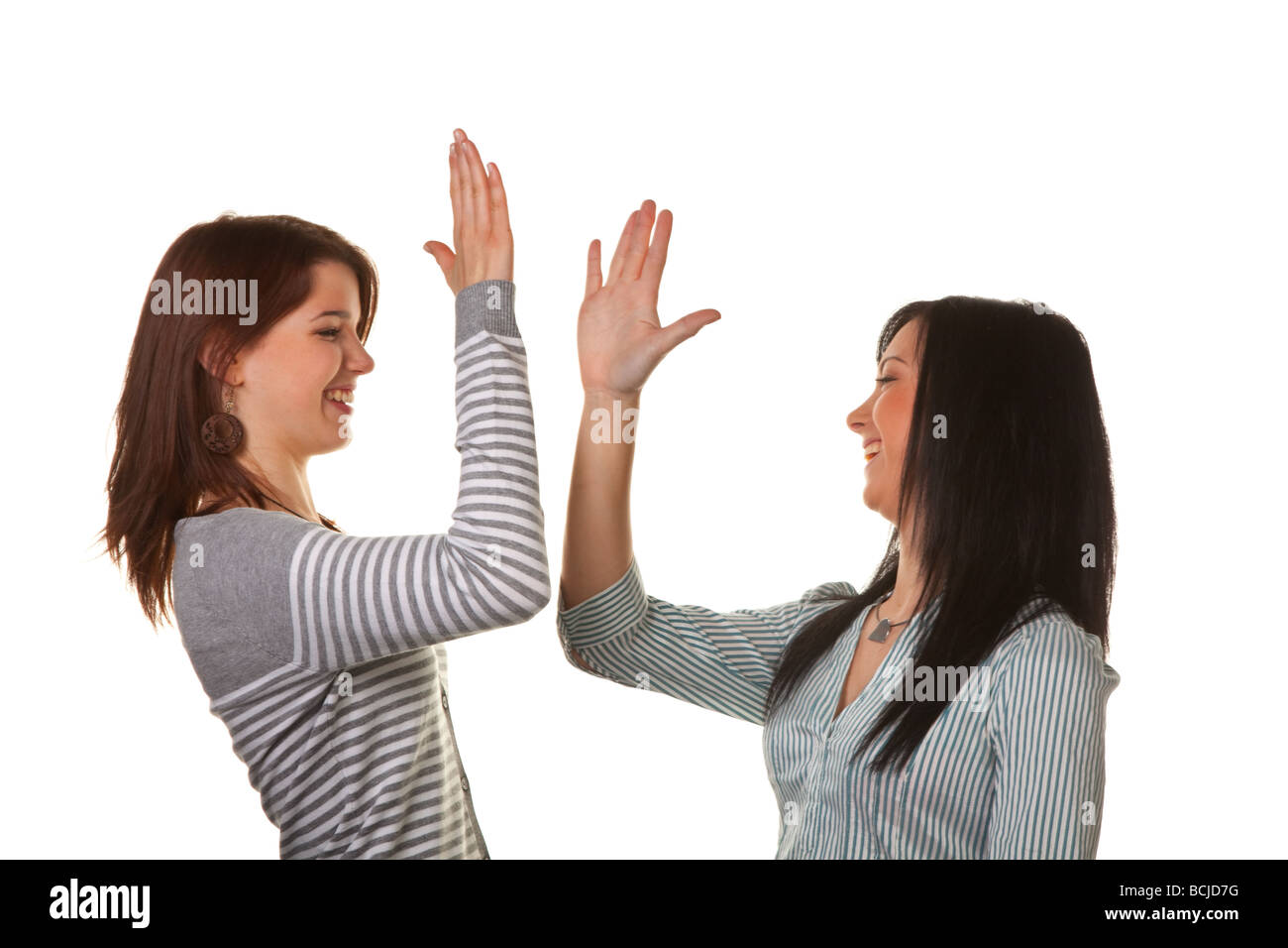 Two young girls handshake and agree Stock Photo - Alamy
