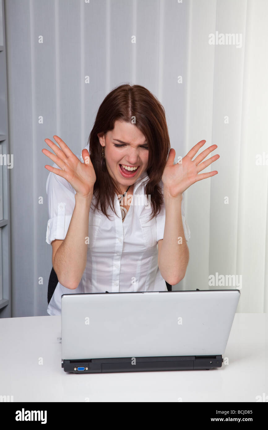 Desperate young woman facing a problem on the laptop Stock Photo - Alamy