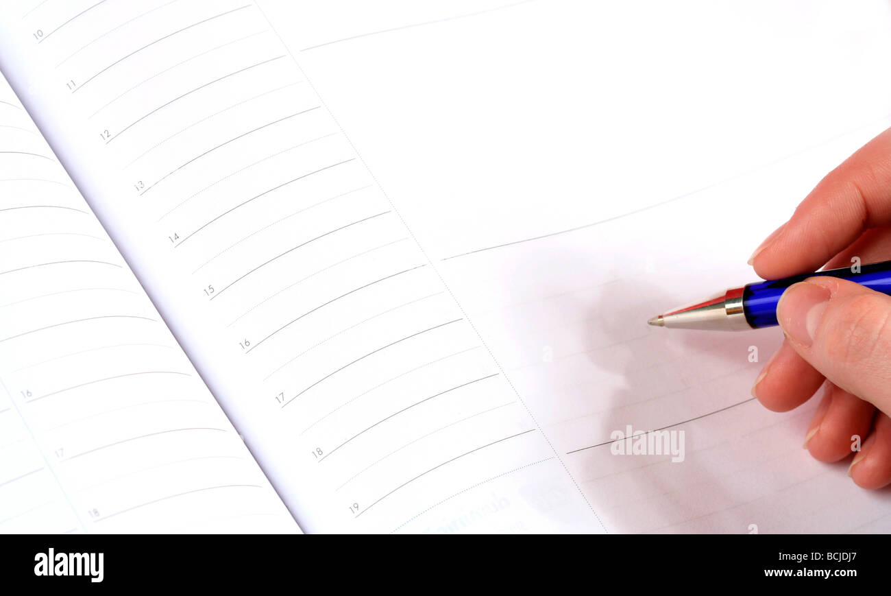 Close-up of woman hand writing in agenda Stock Photo - Alamy