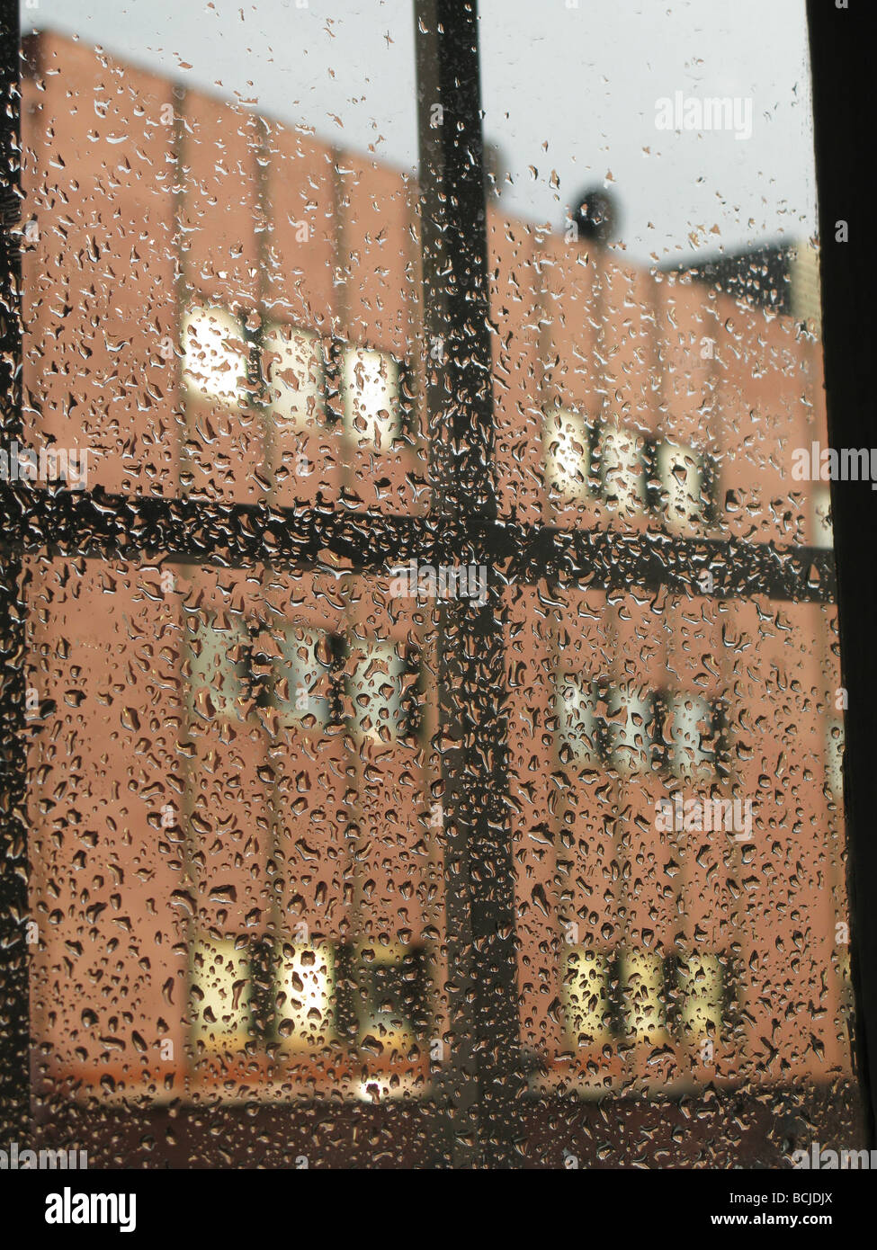 modern office block seen through rain drops covered window Stock Photo ...