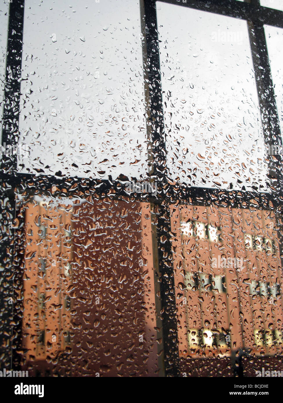 modern office block seen through rain drops covered window Stock Photo ...