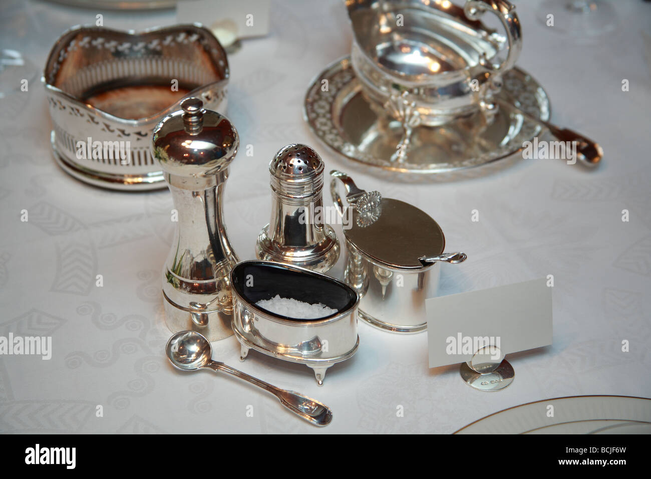Formal table setting with silver condiments Stock Photo - Alamy