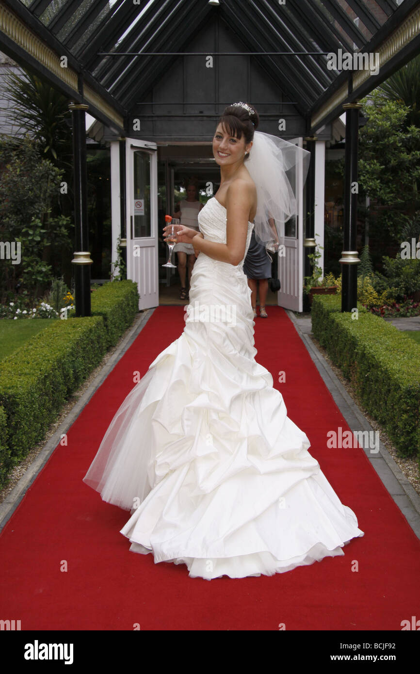 Bride at her reception on a red carpet Stock Photo - Alamy