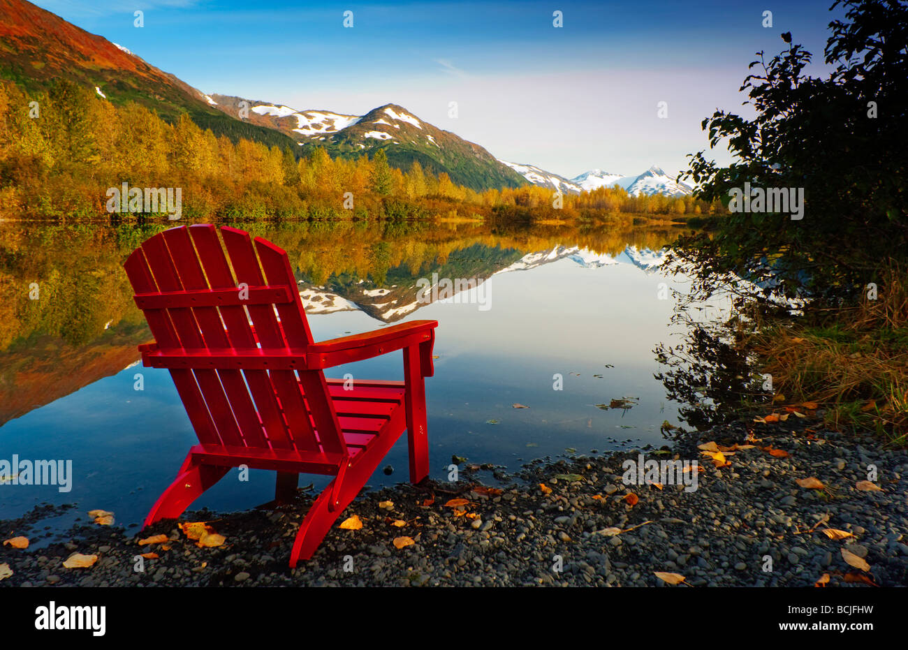 Red Adirondak chair along lakeshore, Alaska Stock Photo - Alamy