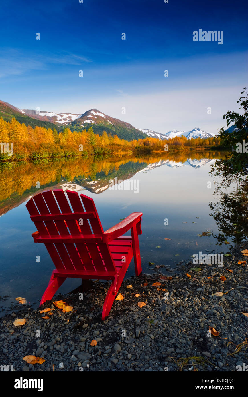 Red Adirondak chair along lakeshore, Alaska Stock Photo - Alamy