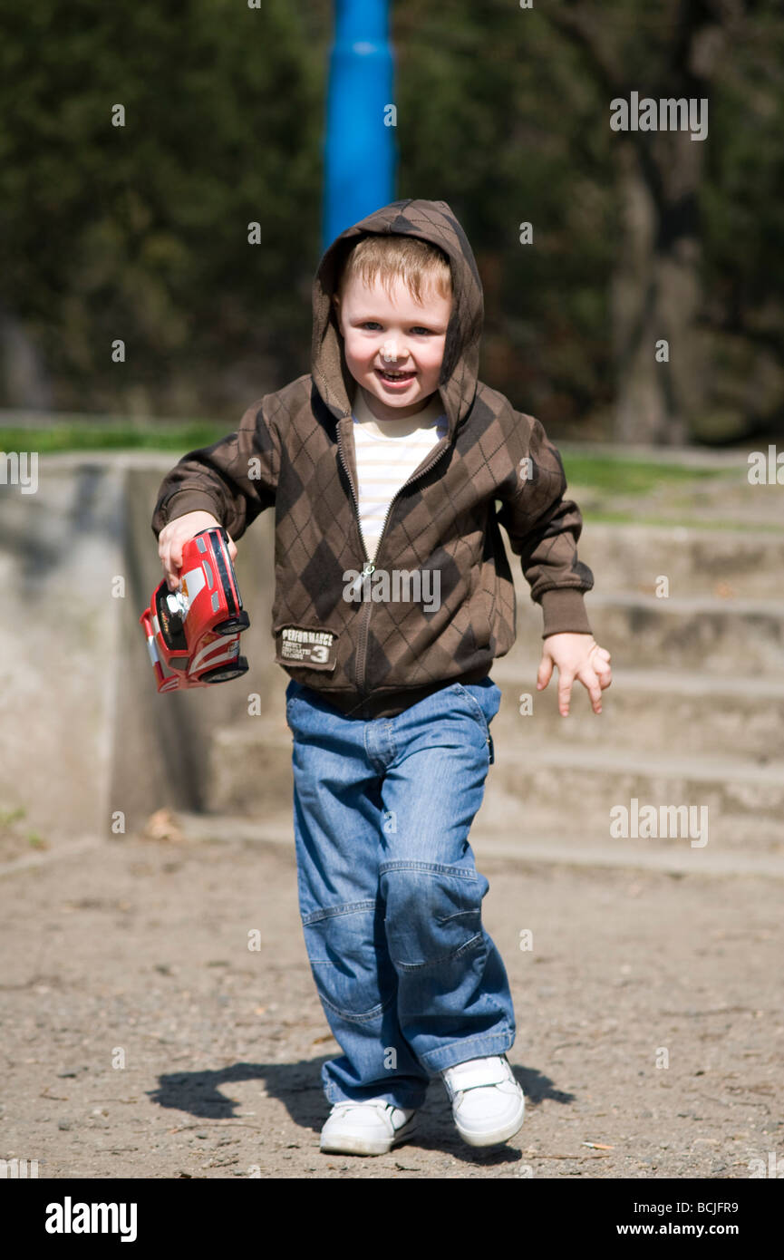 Boy running in park Stock Photo - Alamy