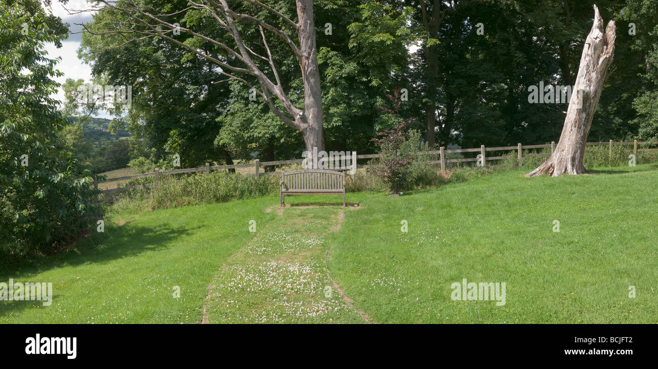 a bench in a country garden Stock Photo - Alamy