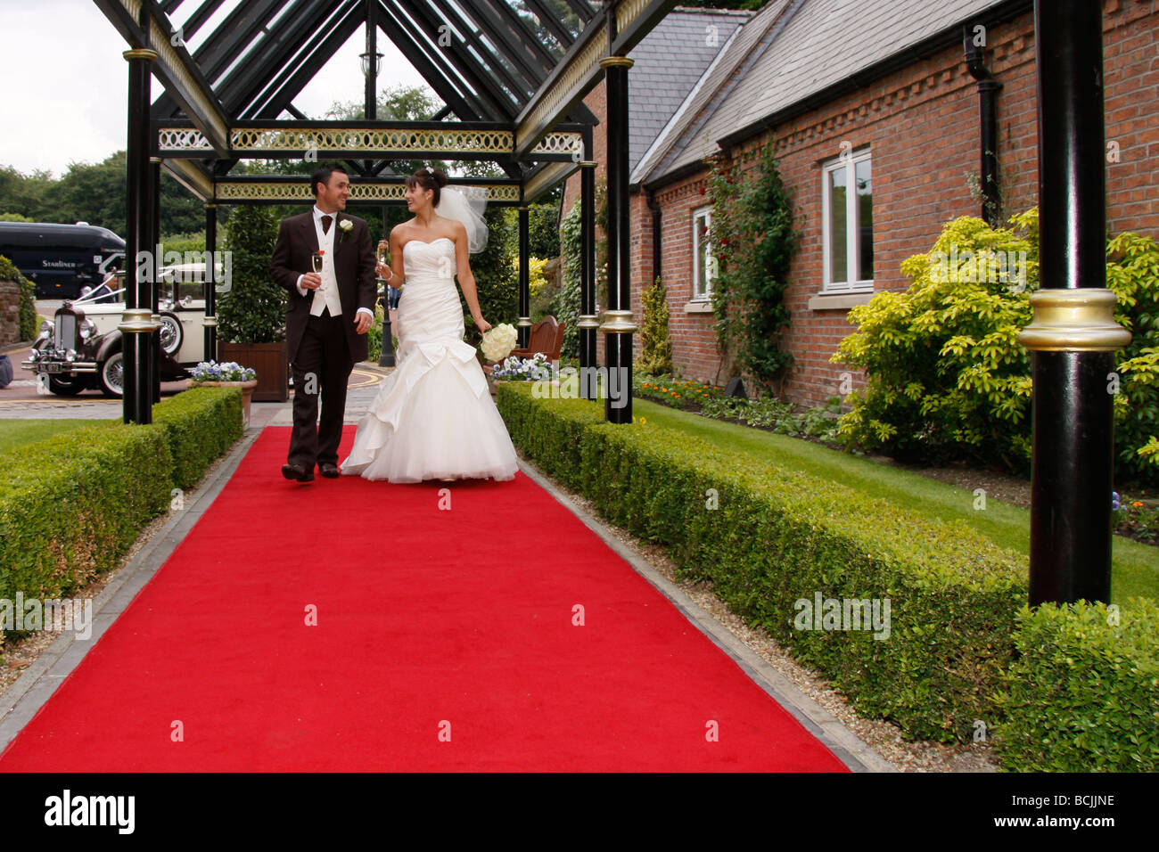 Bride and Groom Arriving at the reception on a red carpet Stock Photo ...