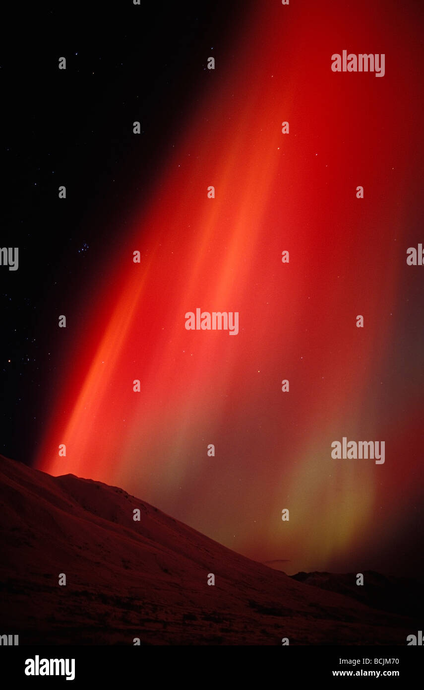 Bright red aurora lights up the winter night sky above Hatcher Pass in ...
