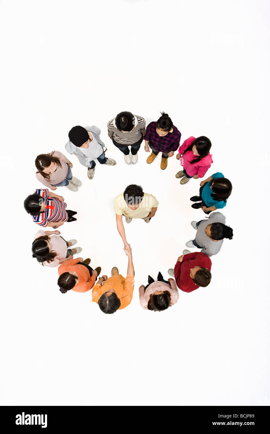 Person in circle shaking hands Stock Photo - Alamy