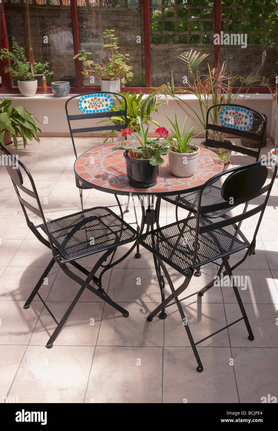 conservatory tables chairs plants room in house next to garden Stock ...