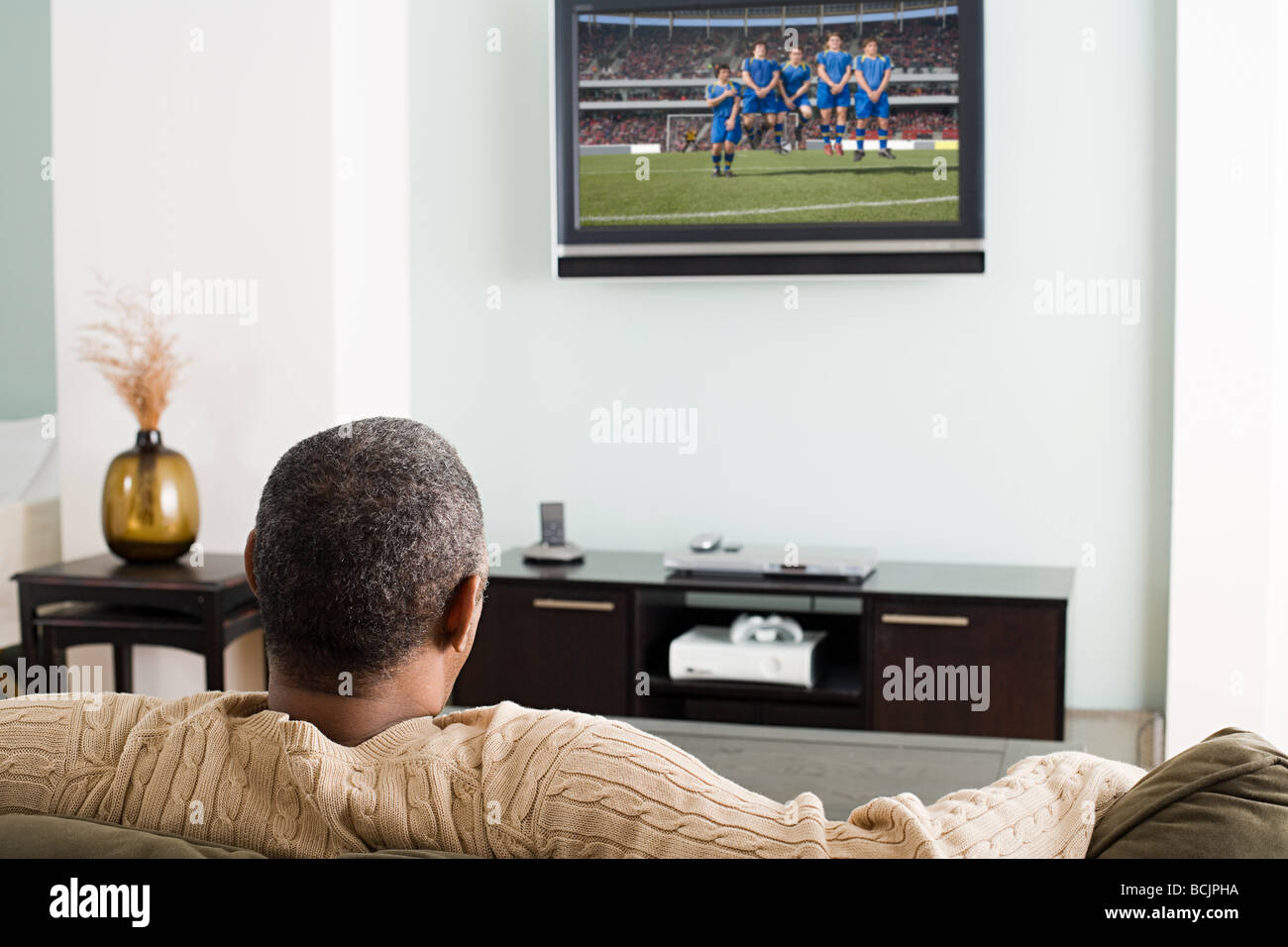 Man watching television Stock Photo - Alamy